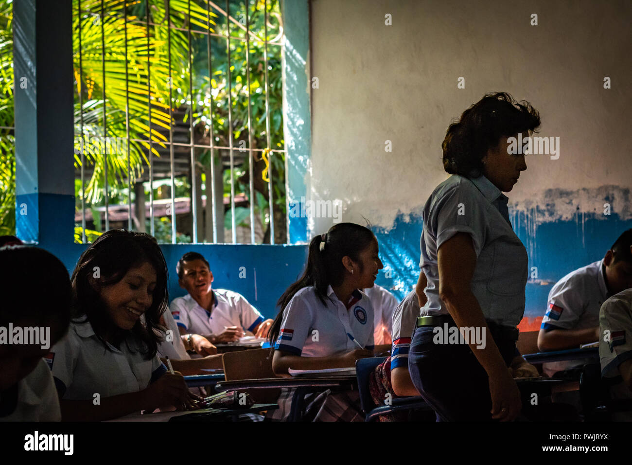teacher helping students in guatemalan college Stock Photo - Alamy