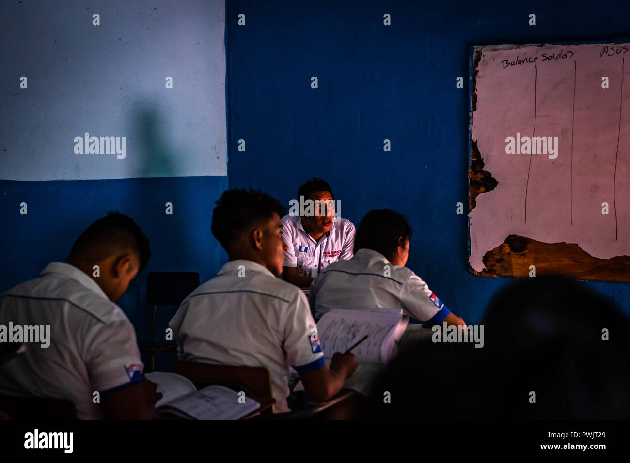 teacher helping students in guatemalan college Stock Photo - Alamy