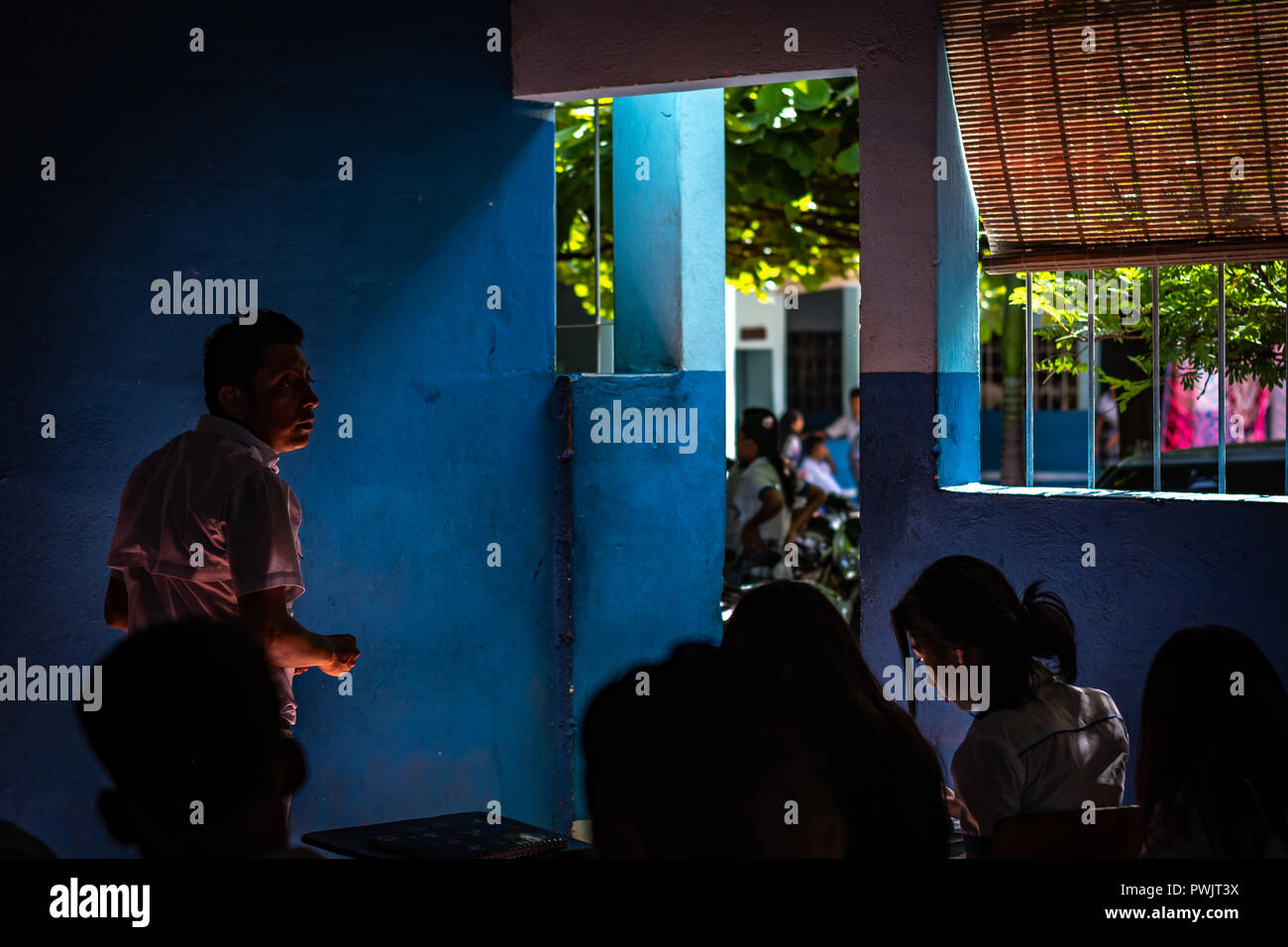 teacher helping students in guatemalan college Stock Photo - Alamy