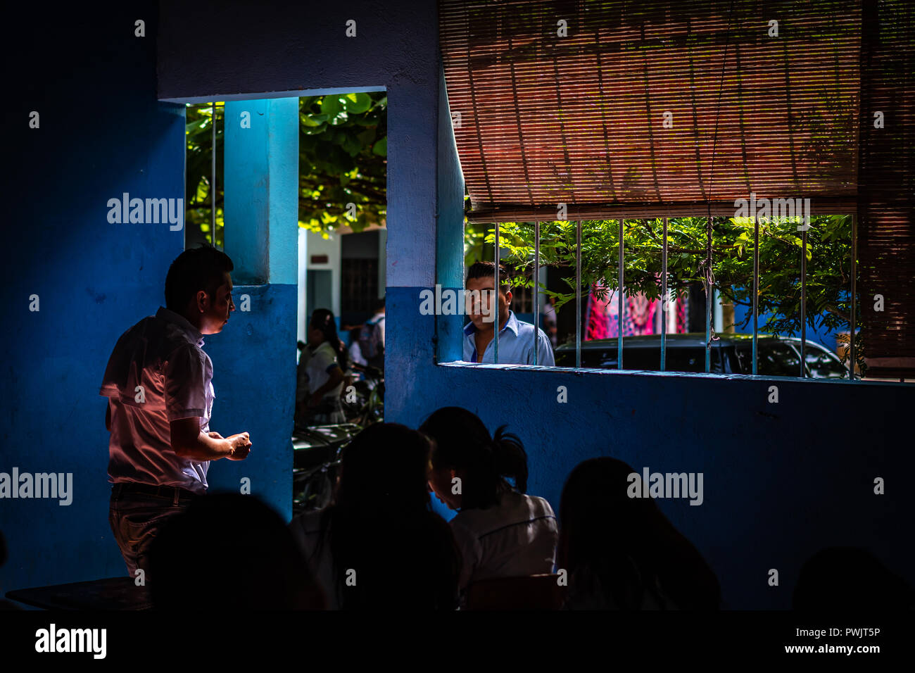 teacher helping students in guatemalan college Stock Photo - Alamy
