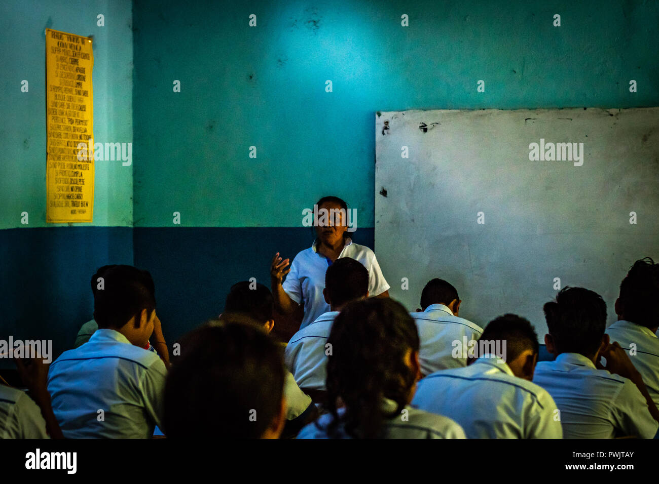 teacher helping students in guatemalan college Stock Photo - Alamy