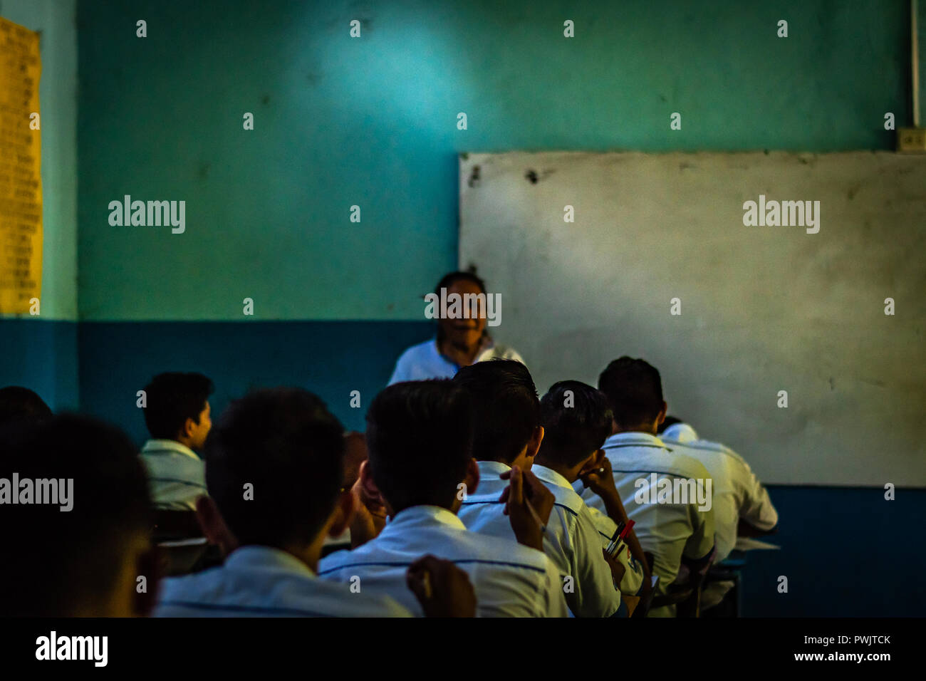 teacher helping students in guatemalan college Stock Photo - Alamy