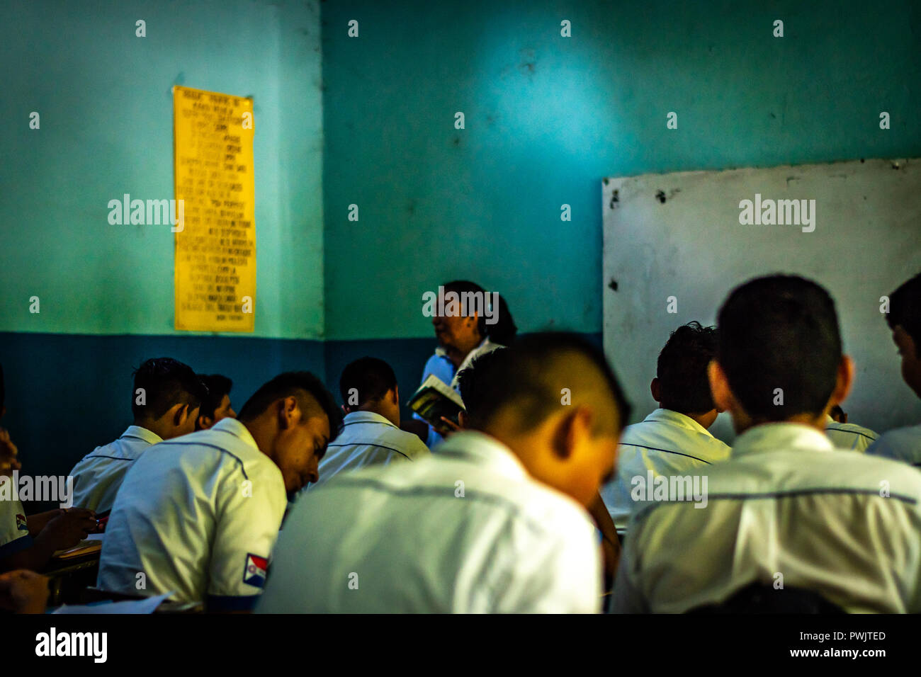 teacher helping students in guatemalan college Stock Photo - Alamy