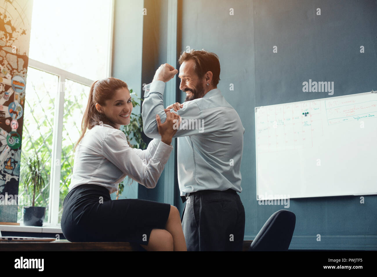 Business people showing muscles hi-res stock photography and images - Alamy