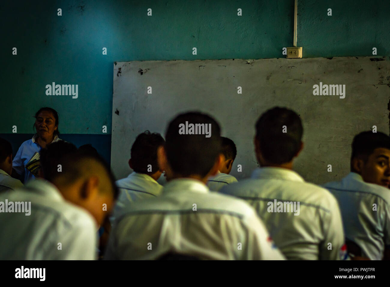 teacher helping students in guatemalan college Stock Photo - Alamy
