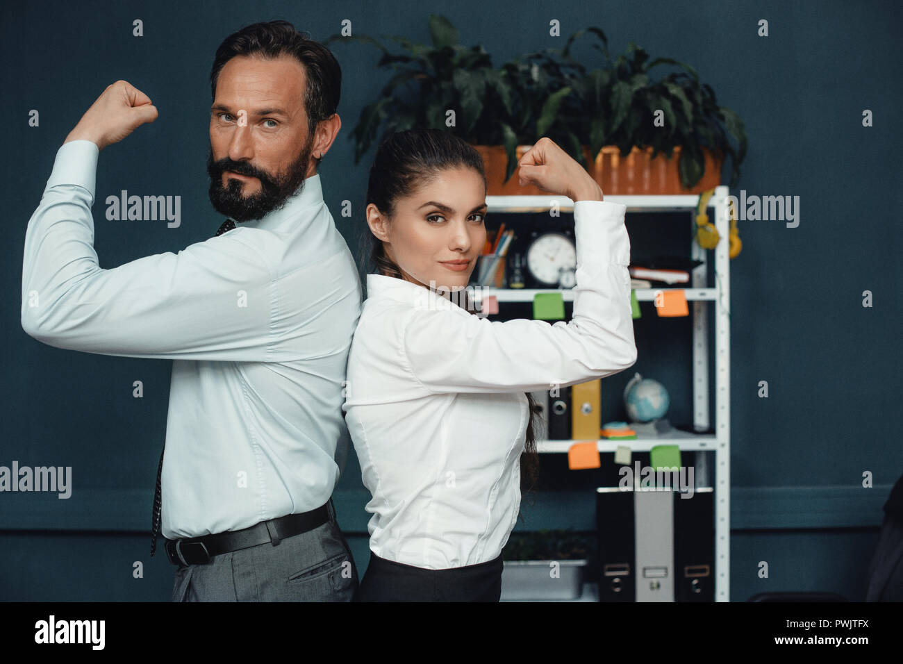 Business people showing muscles in office Stock Photo - Alamy
