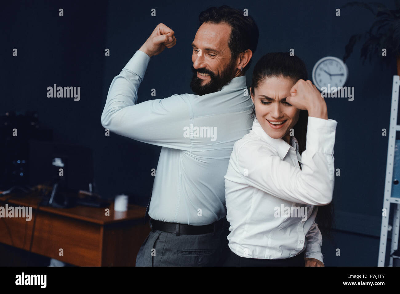 Business people showing muscles in office Stock Photo - Alamy