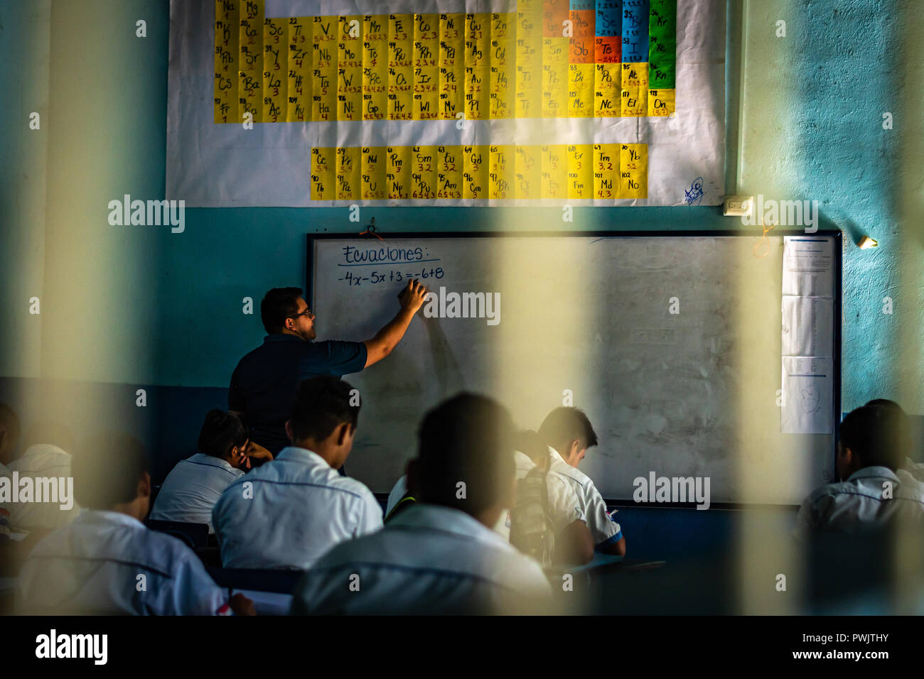 teacher helping students in guatemalan college Stock Photo - Alamy