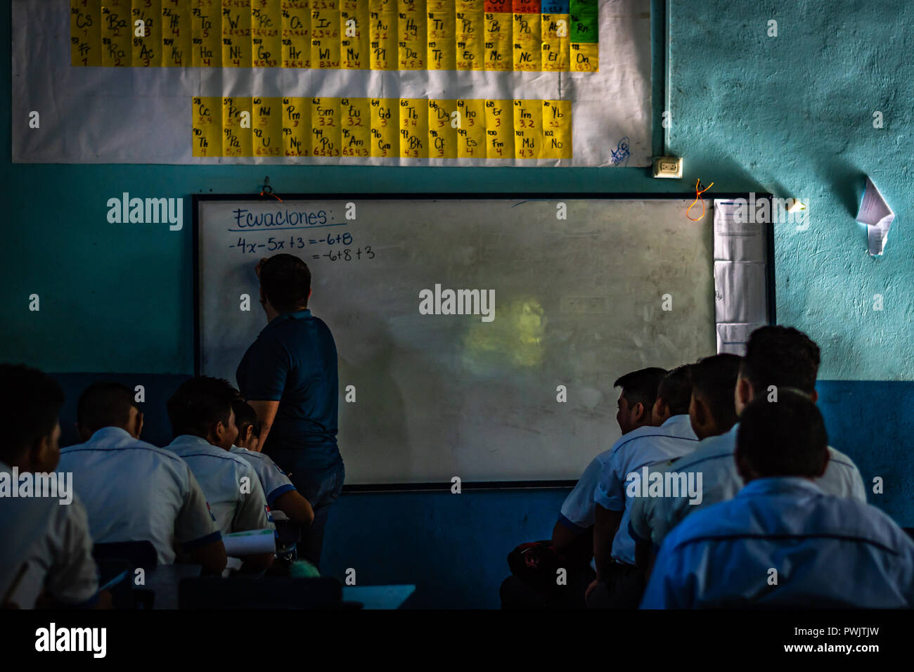 teacher helping students in guatemalan college Stock Photo - Alamy