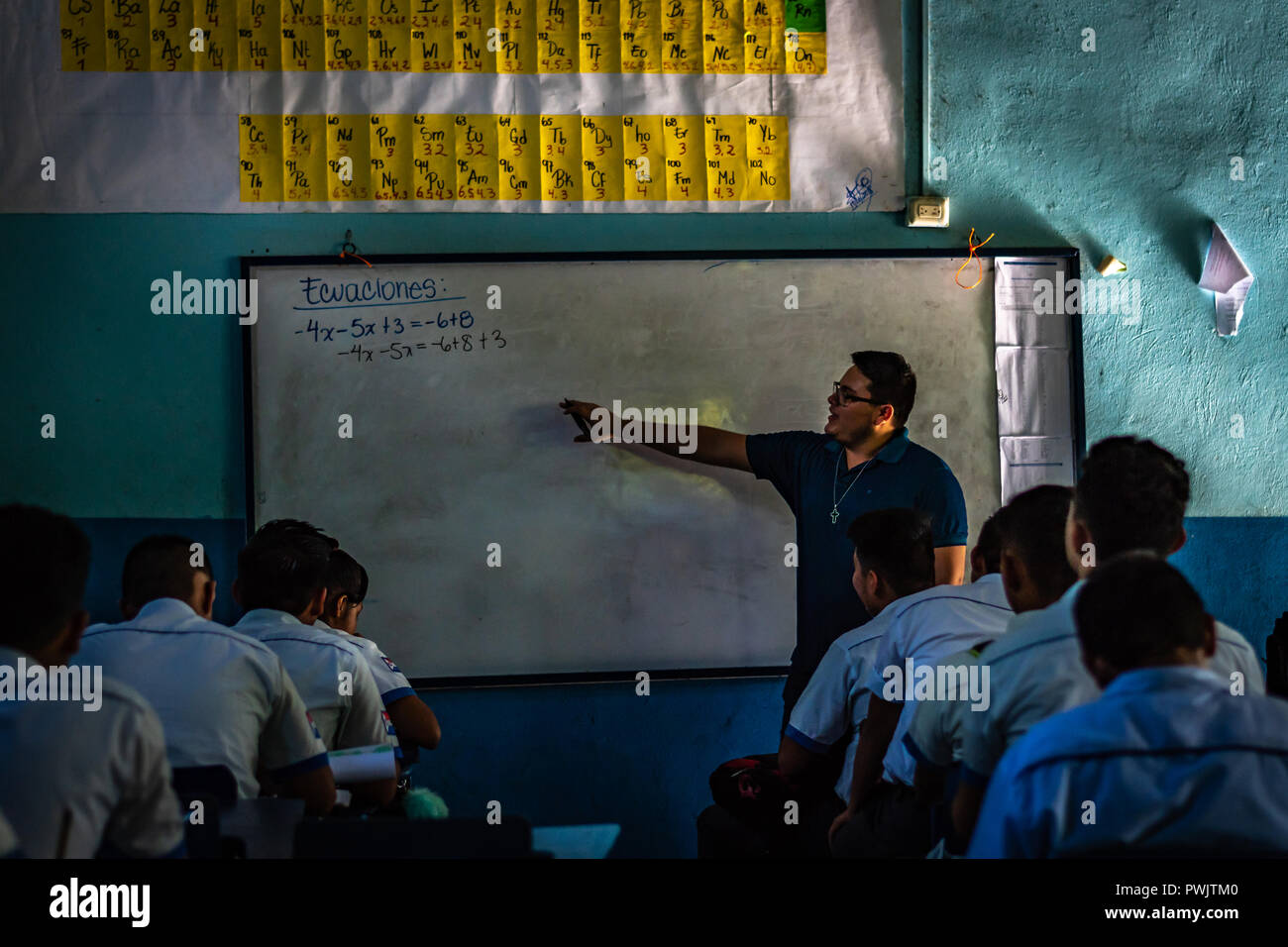 teacher helping students in guatemalan college Stock Photo - Alamy