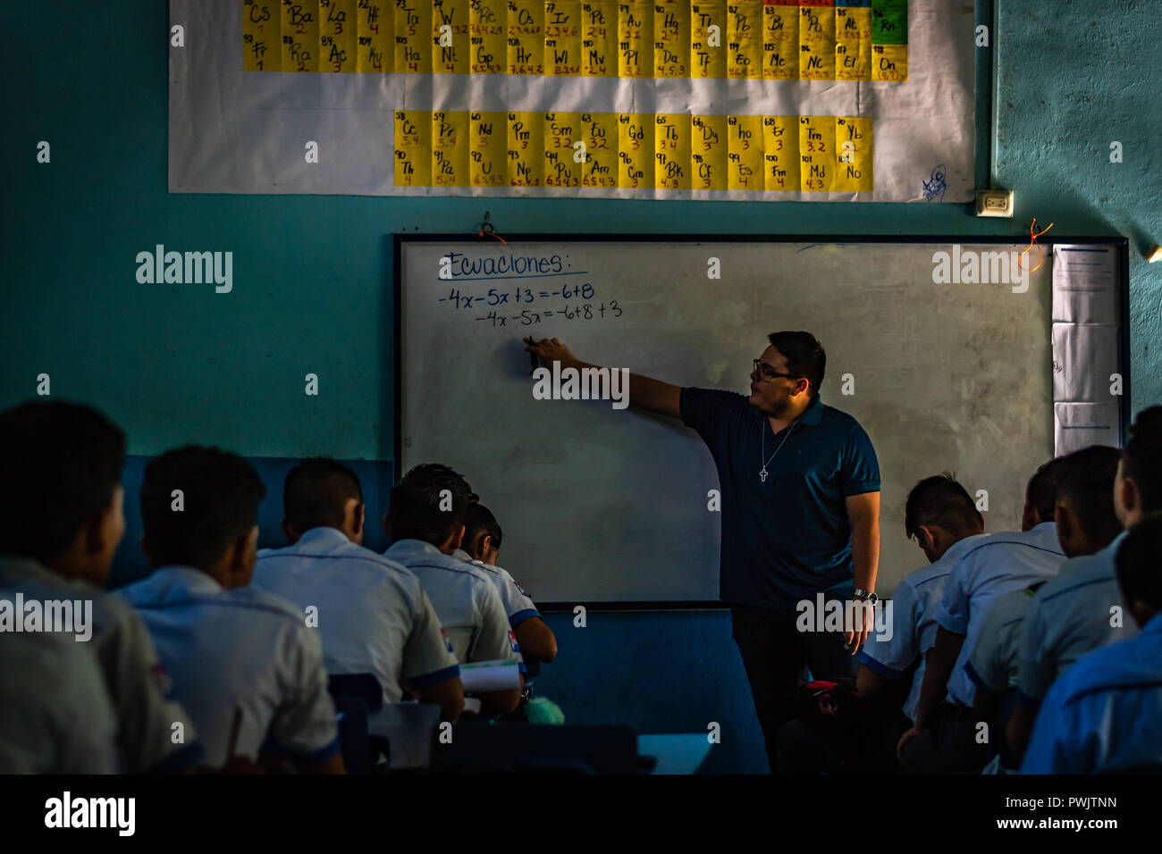 teacher helping students in guatemalan college Stock Photo - Alamy