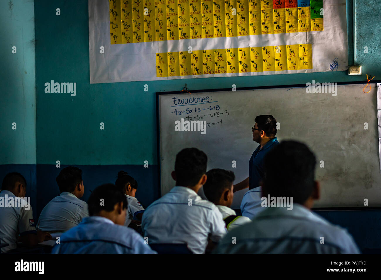 teacher helping students in guatemalan college Stock Photo - Alamy