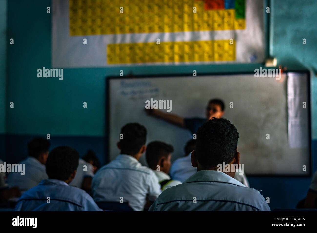 teacher helping students in guatemalan college Stock Photo - Alamy