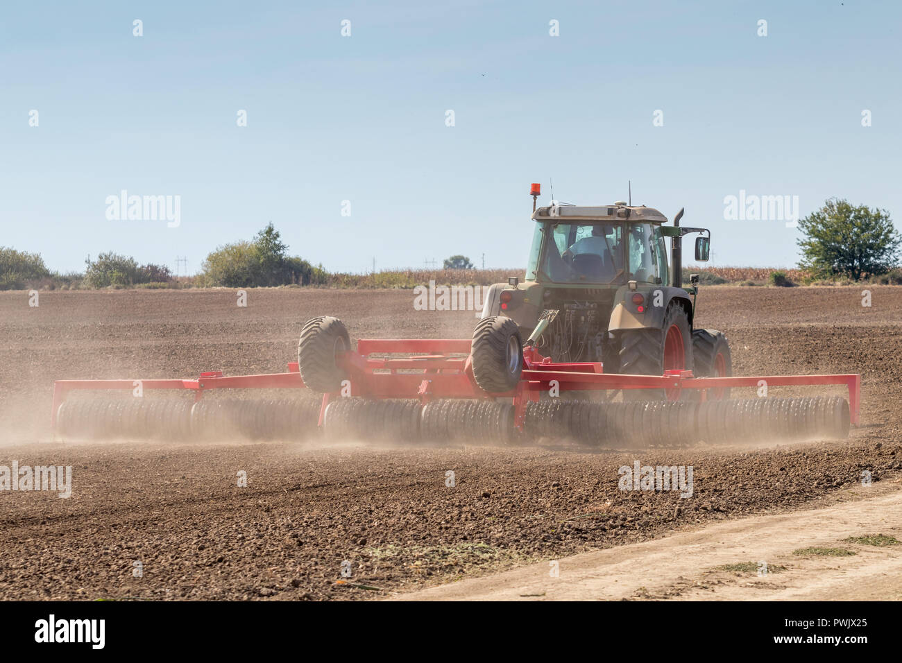 Tractor preparing field, Agriculture tractor Stock Photo - Alamy