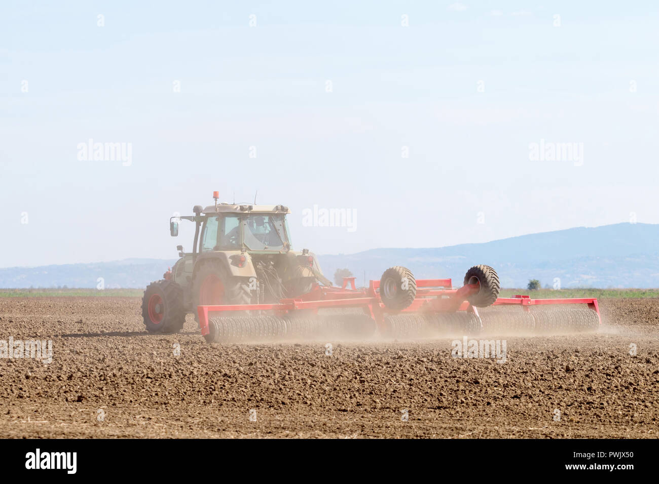 Tractor preparing field, Agriculture tractor Stock Photo - Alamy