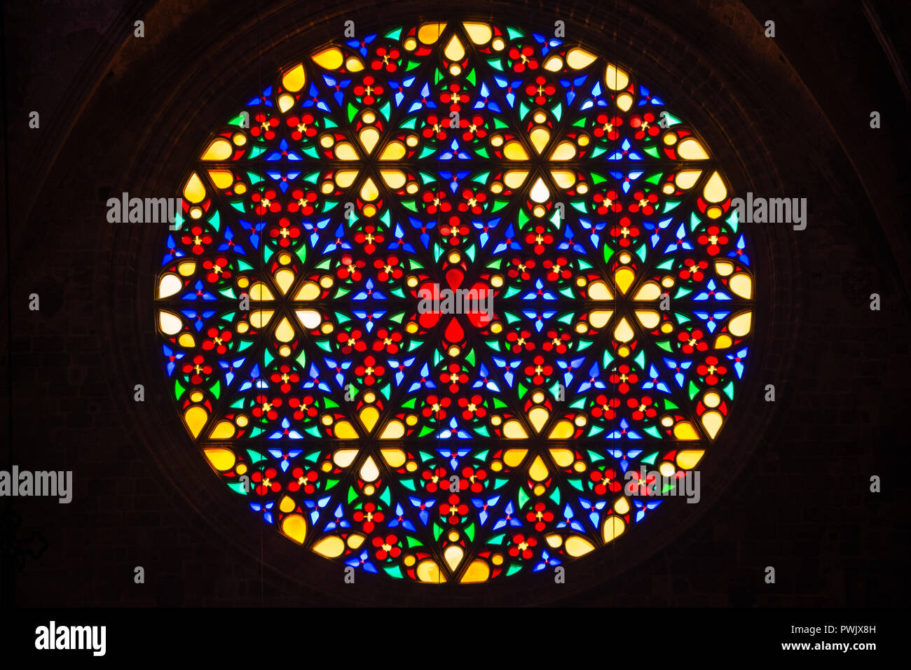 Multi colored stained glass window with flower prints Stock Photo - Alamy