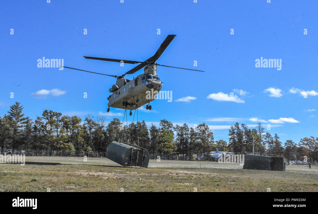 A CH-47 Chinook sling loads a bridging section from Grayling Army ...