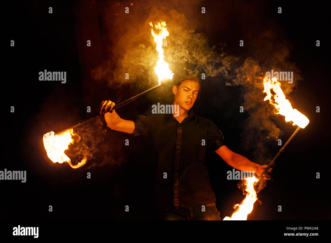 Fire show. Fire dancer dances with two Staff. Night performance ...
