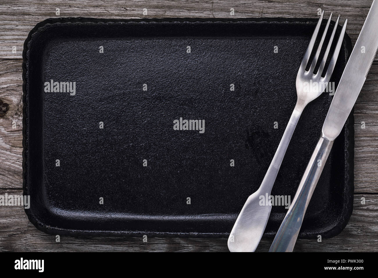 Cutlery and cast iron baking sheet with copy space. Food background ...
