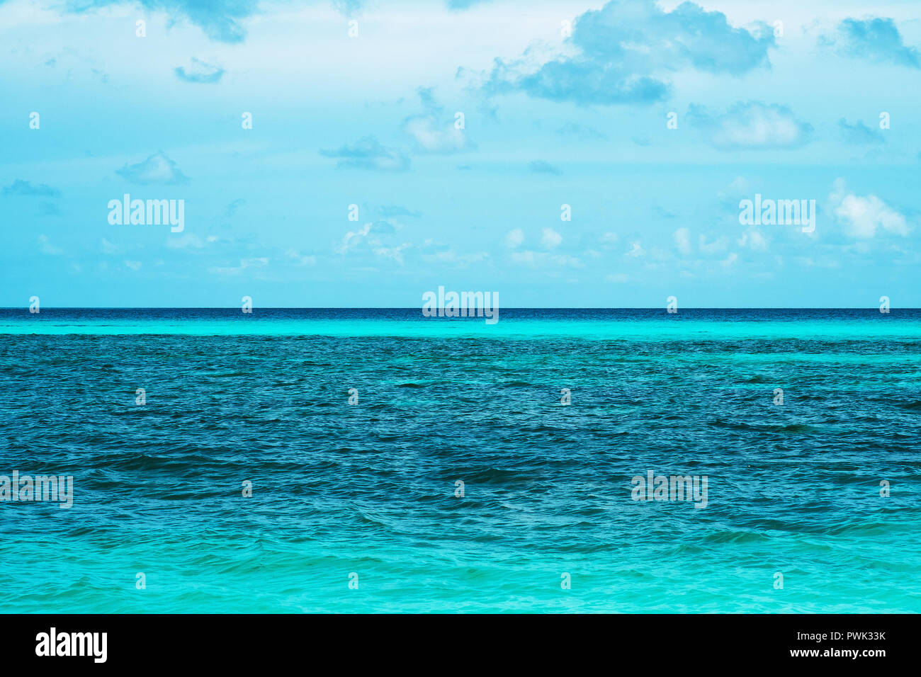 Turquoise ocean and sky with clouds. Background Stock Photo - Alamy