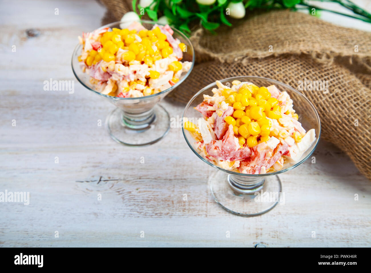 Delicious salad of crab sticks, cheese, tomato and corn Stock Photo - Alamy