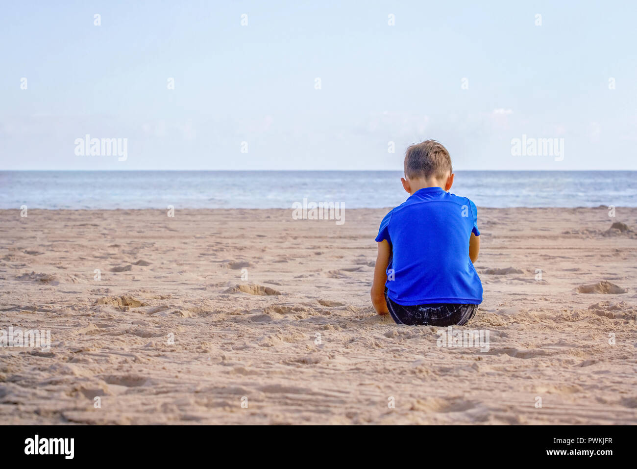Sad Kid Sitting High Resolution Stock Photography and Images - Alamy