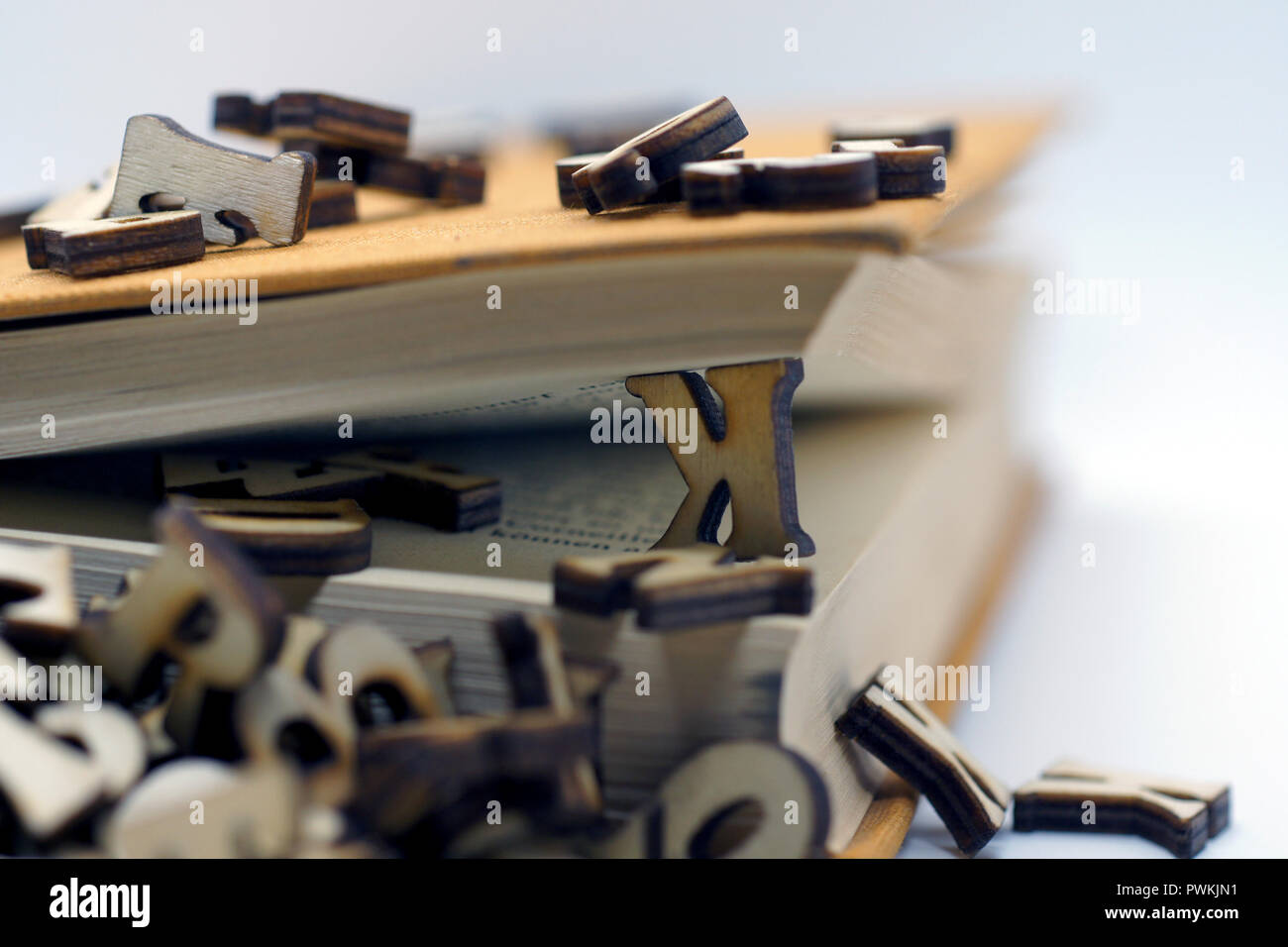 old book with hard cover and falling letters Stock Photo - Alamy