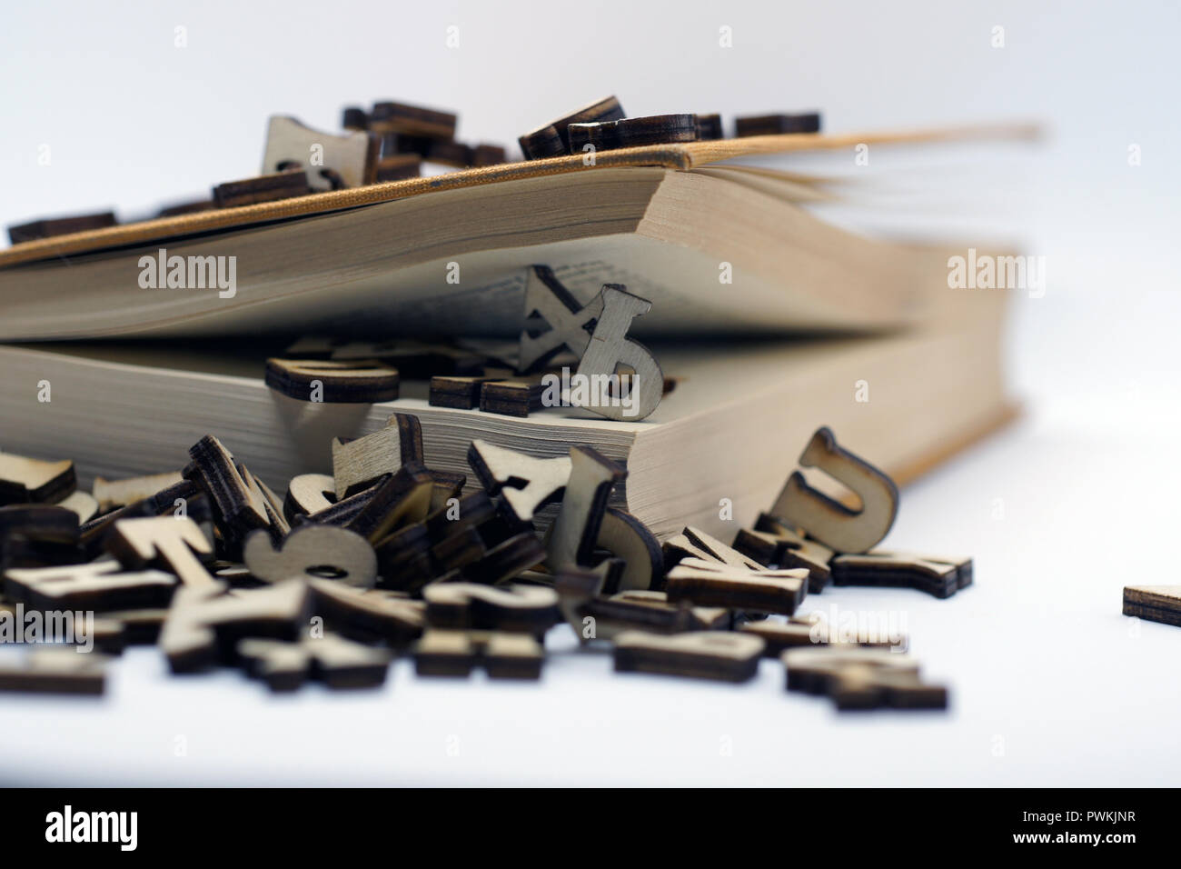 old book with hard cover and falling letters Stock Photo - Alamy