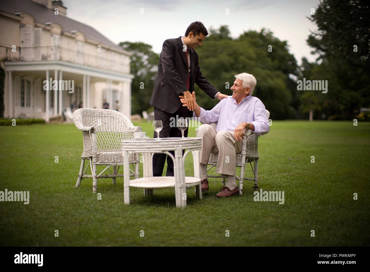 View of two gentlemen in formal attire shaking hands Stock Photo - Alamy