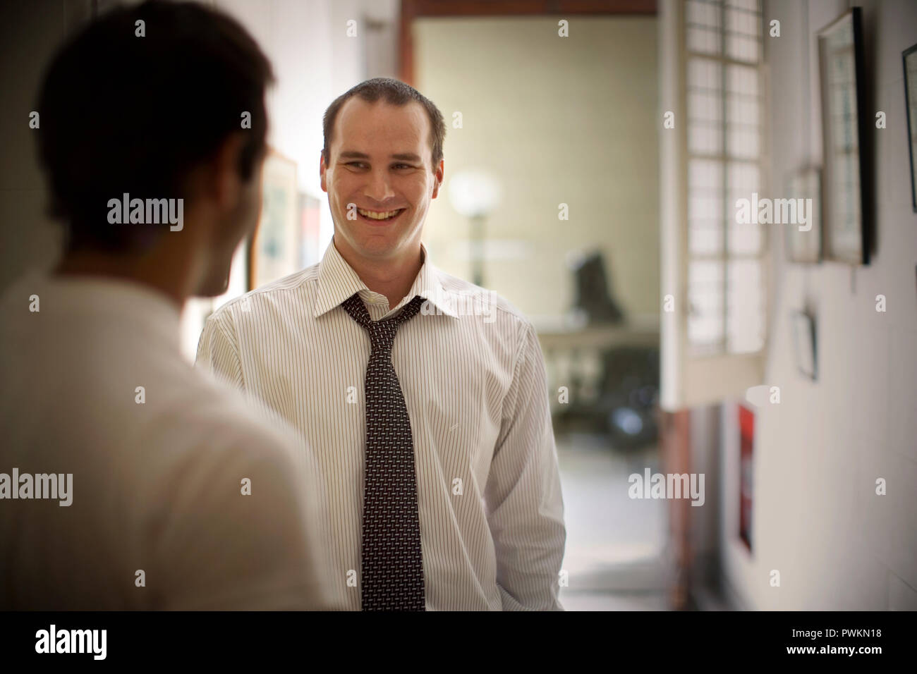View of two men talking to each other Stock Photo - Alamy
