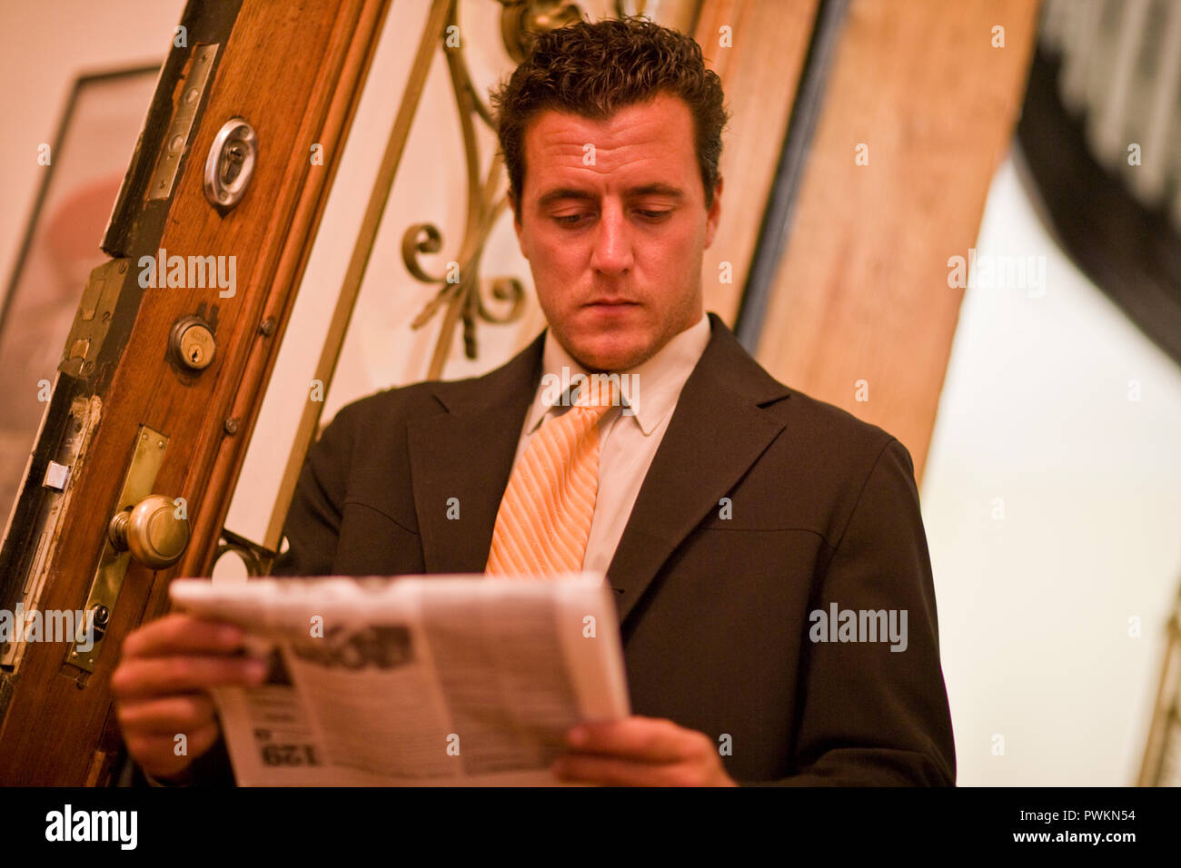 A man reading a newspaper Stock Photo - Alamy