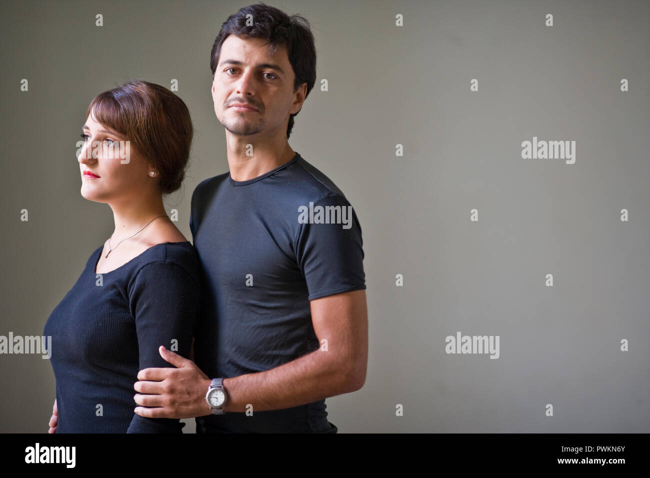 Portrait of a smiling mid-adult man touching his wife's arm while ...