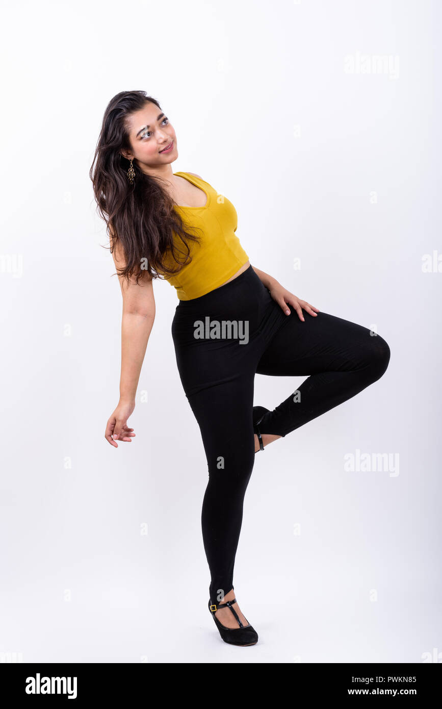 Full body shot of young beautiful Indian woman posing while thin Stock ...