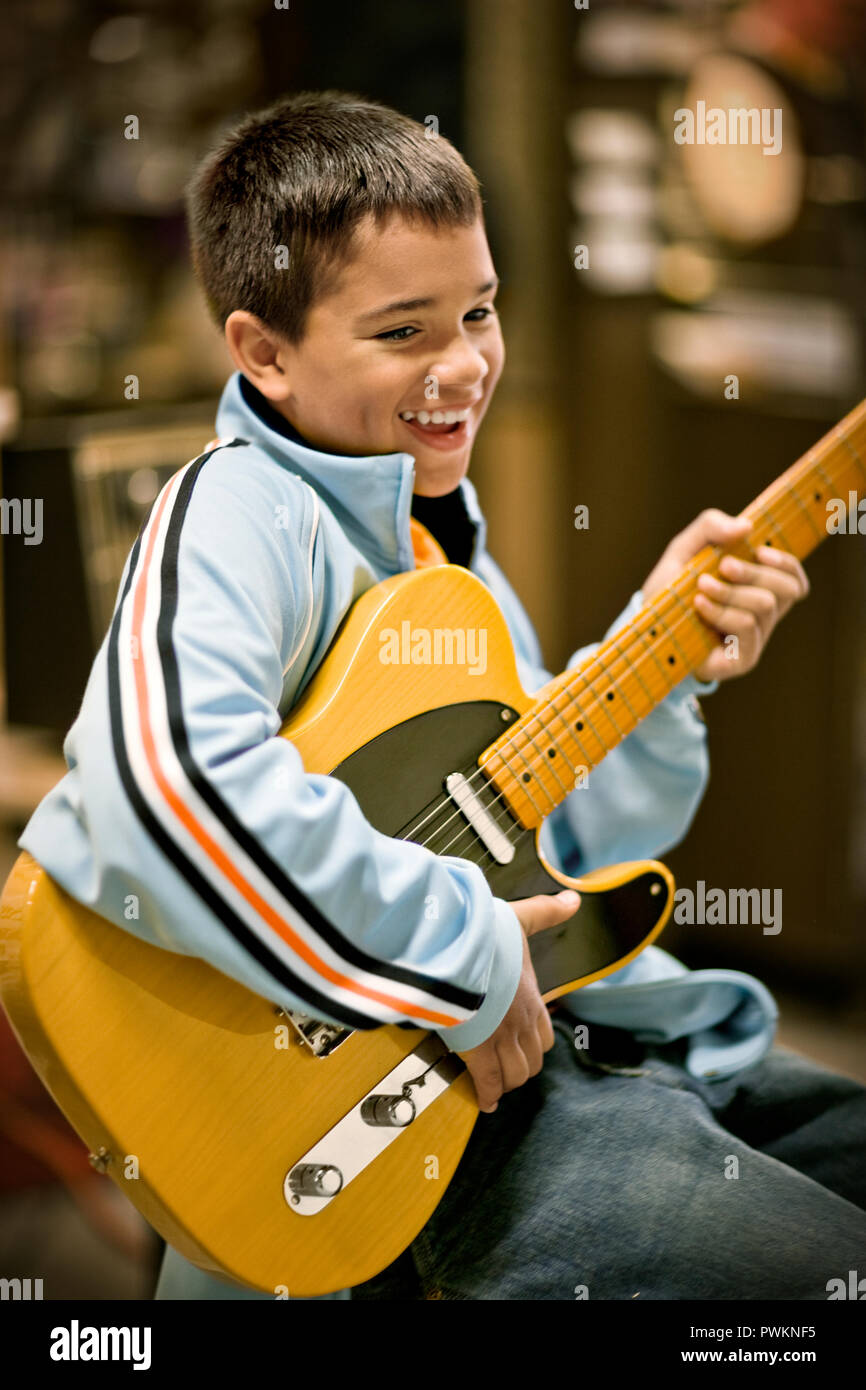 Hispanic children playing instruments hi-res stock photography and ...