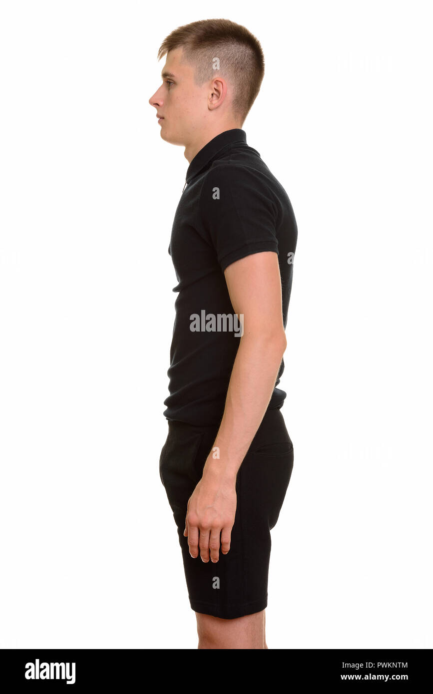 Profile view of young Caucasian man standing Stock Photo - Alamy