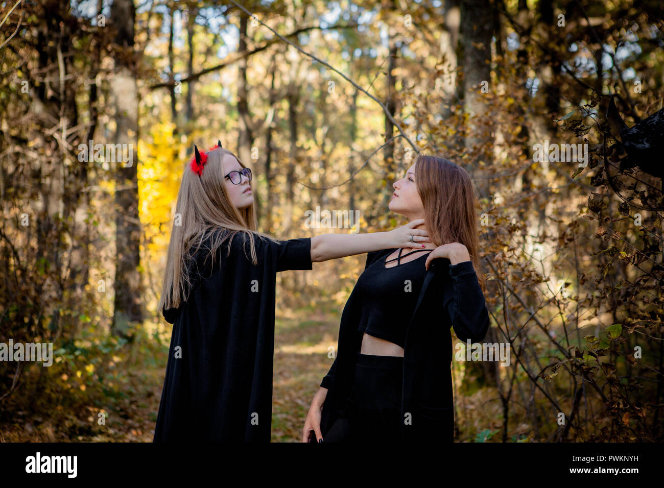 Halloween demon and witch in the woods Stock Photo - Alamy