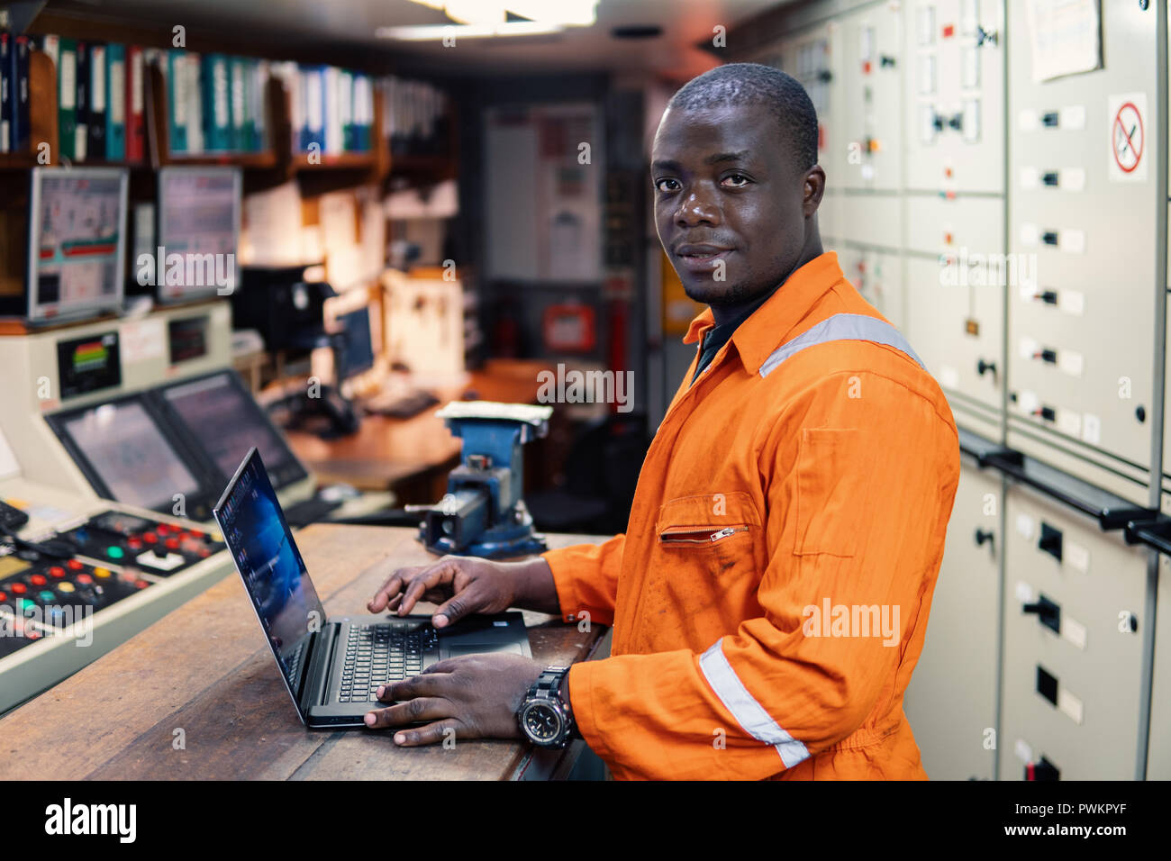 Marine engineer officer working in engine room Stock Photo - Alamy