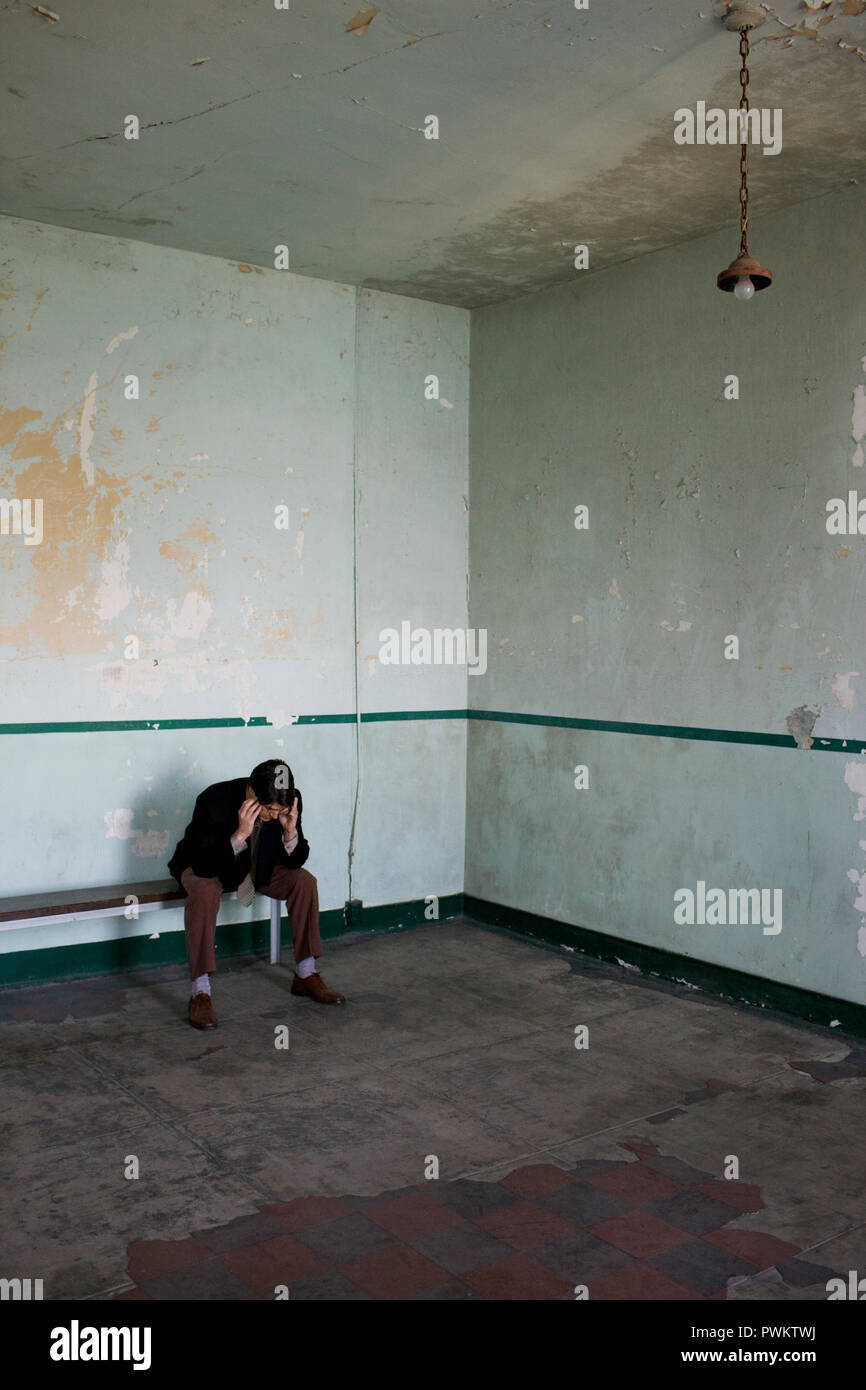 Man sitting head in hands prison cell hi-res stock photography and ...