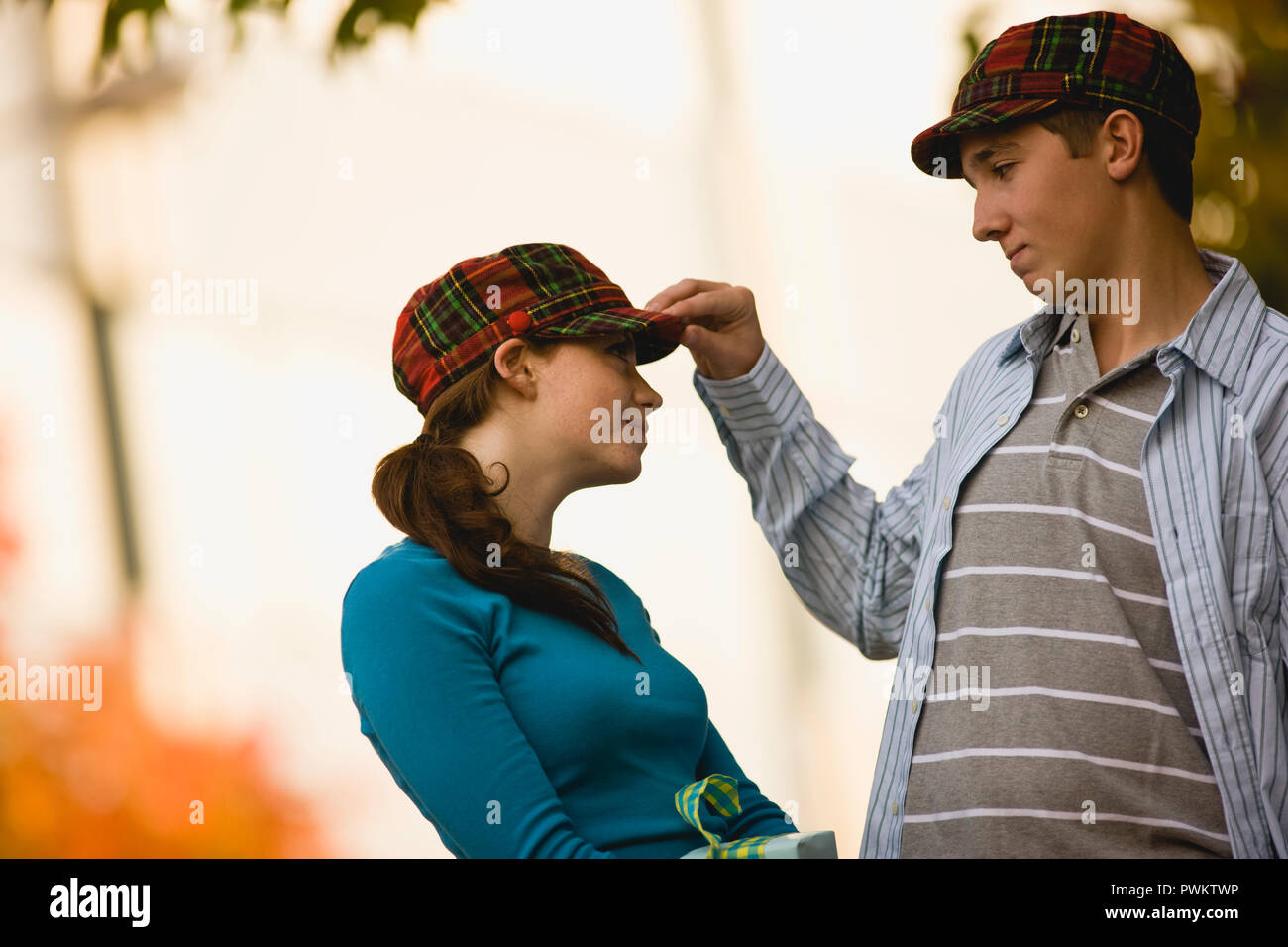Teenage couple wearing matching plaid hats Stock Photo - Alamy