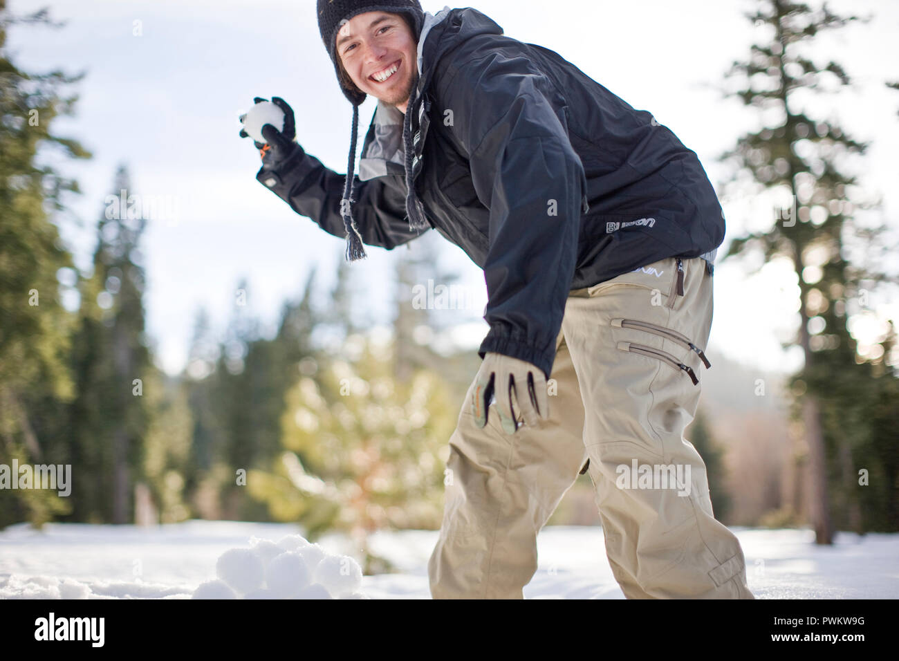 Young man preparing to throw a snowball Stock Photo - Alamy