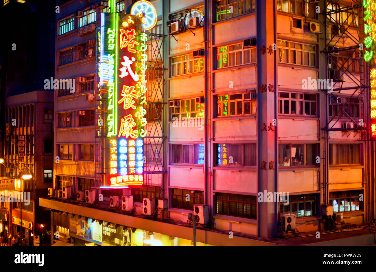 Neon signs on buildings in an urban city at night Stock Photo - Alamy