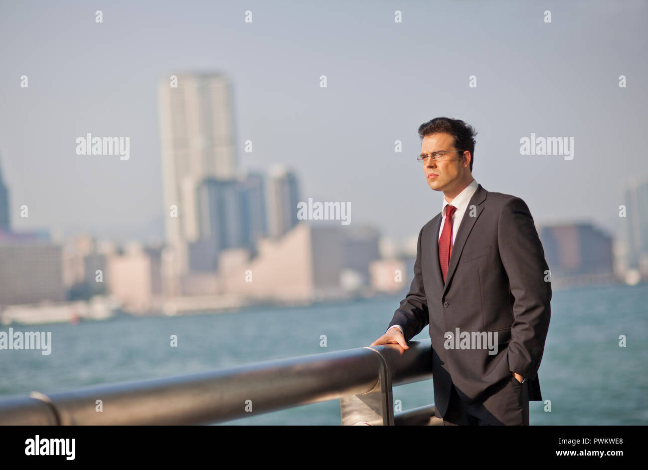 Thoughtful executive looking city contemplating hi-res stock ...