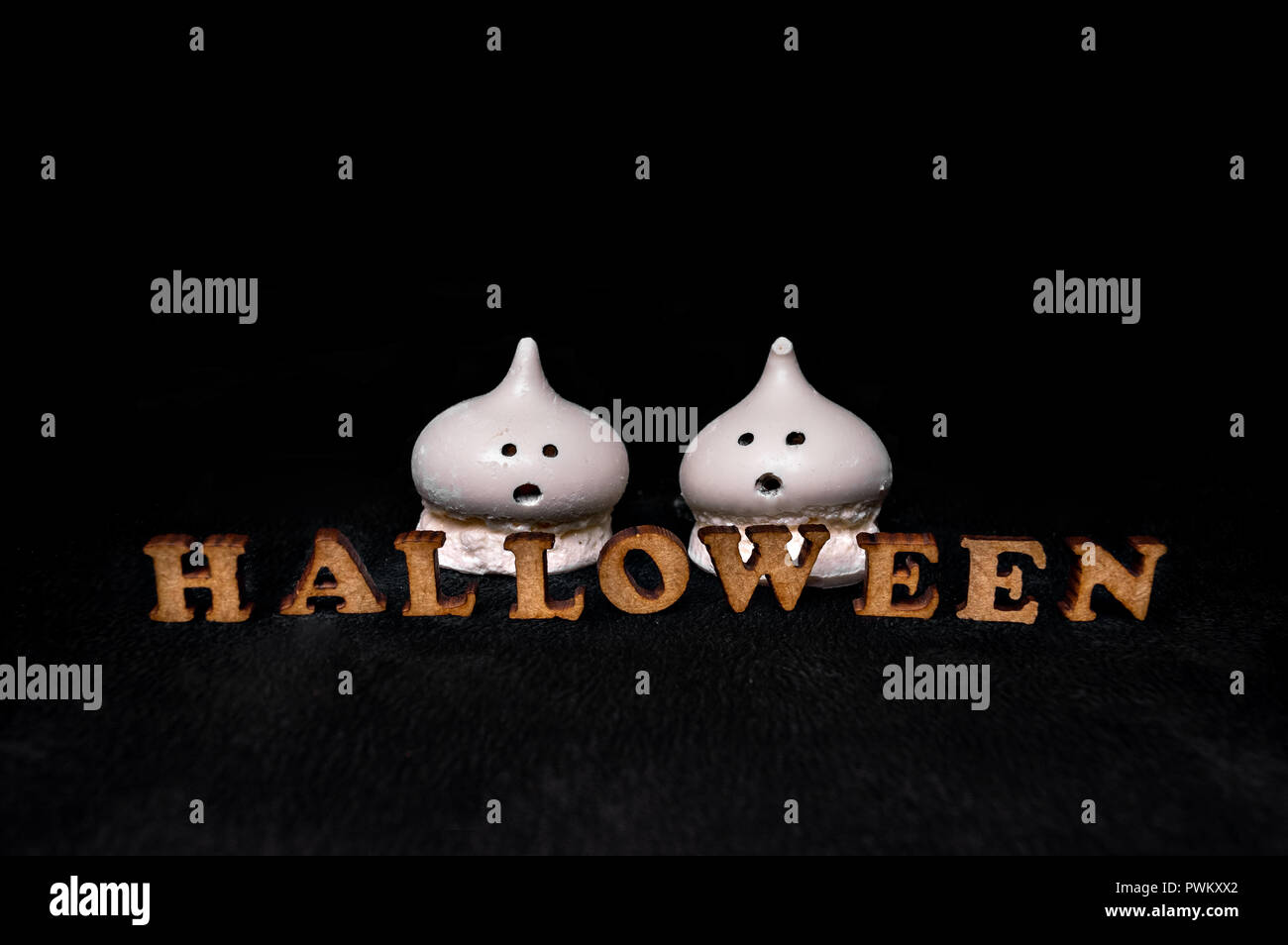 Little candy ghosts with the word Halloween isolated on black ...