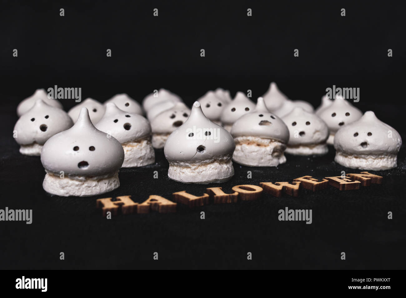 Little candy ghosts with the word Halloween isolated on black ...