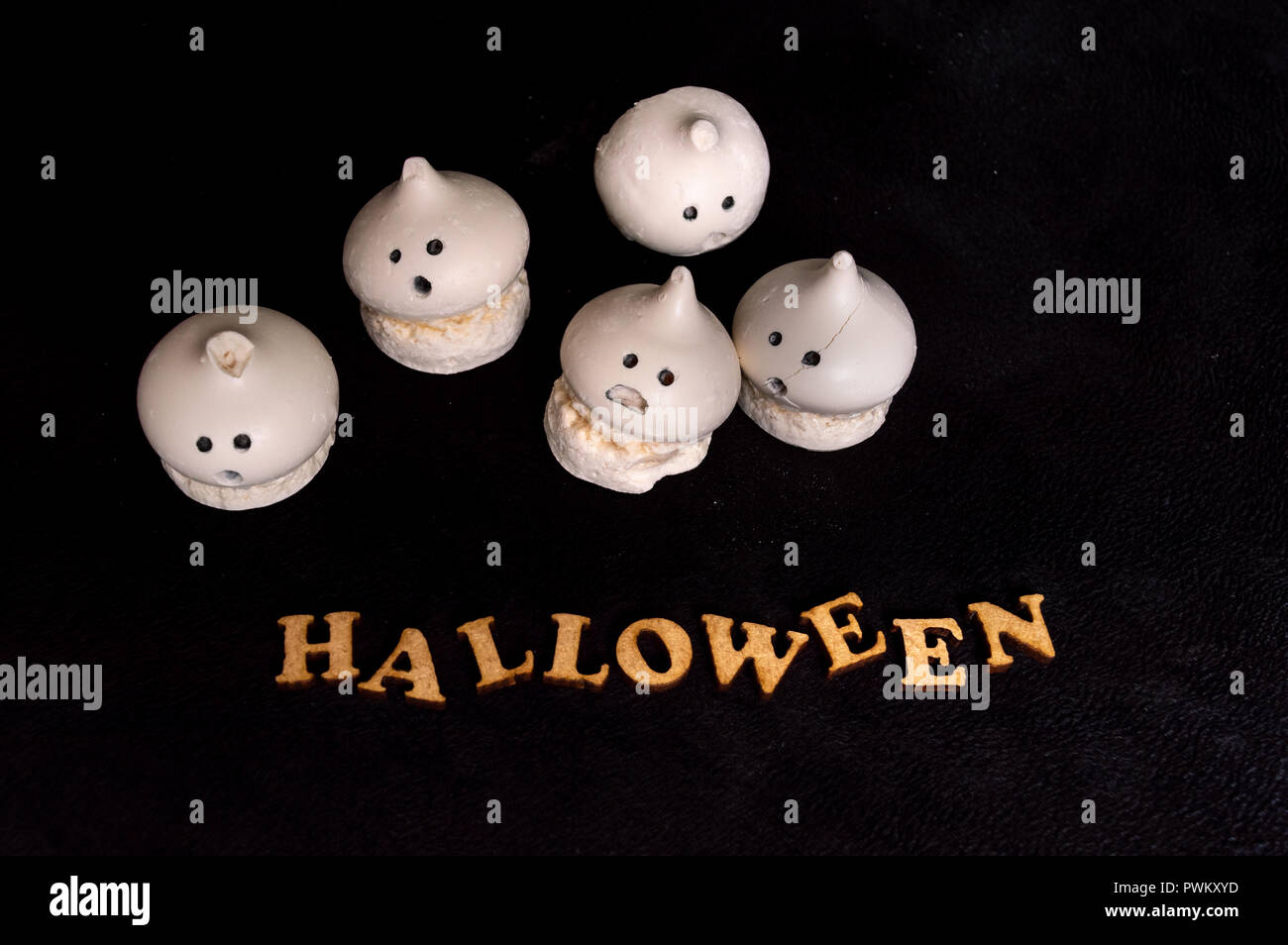 Little candy ghosts with the word Halloween isolated on black ...
