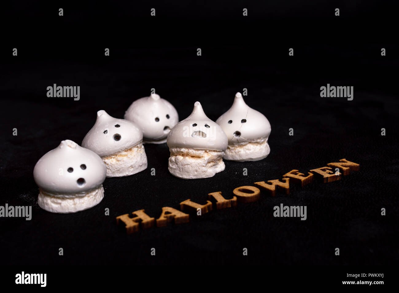 Little candy ghosts with the word Halloween isolated on black ...