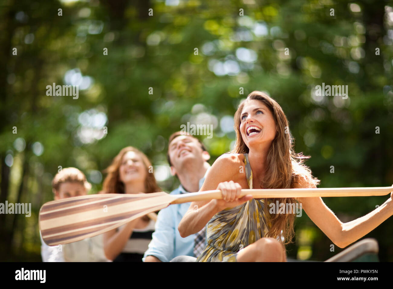 Four friends having fun while canoeing Stock Photo - Alamy