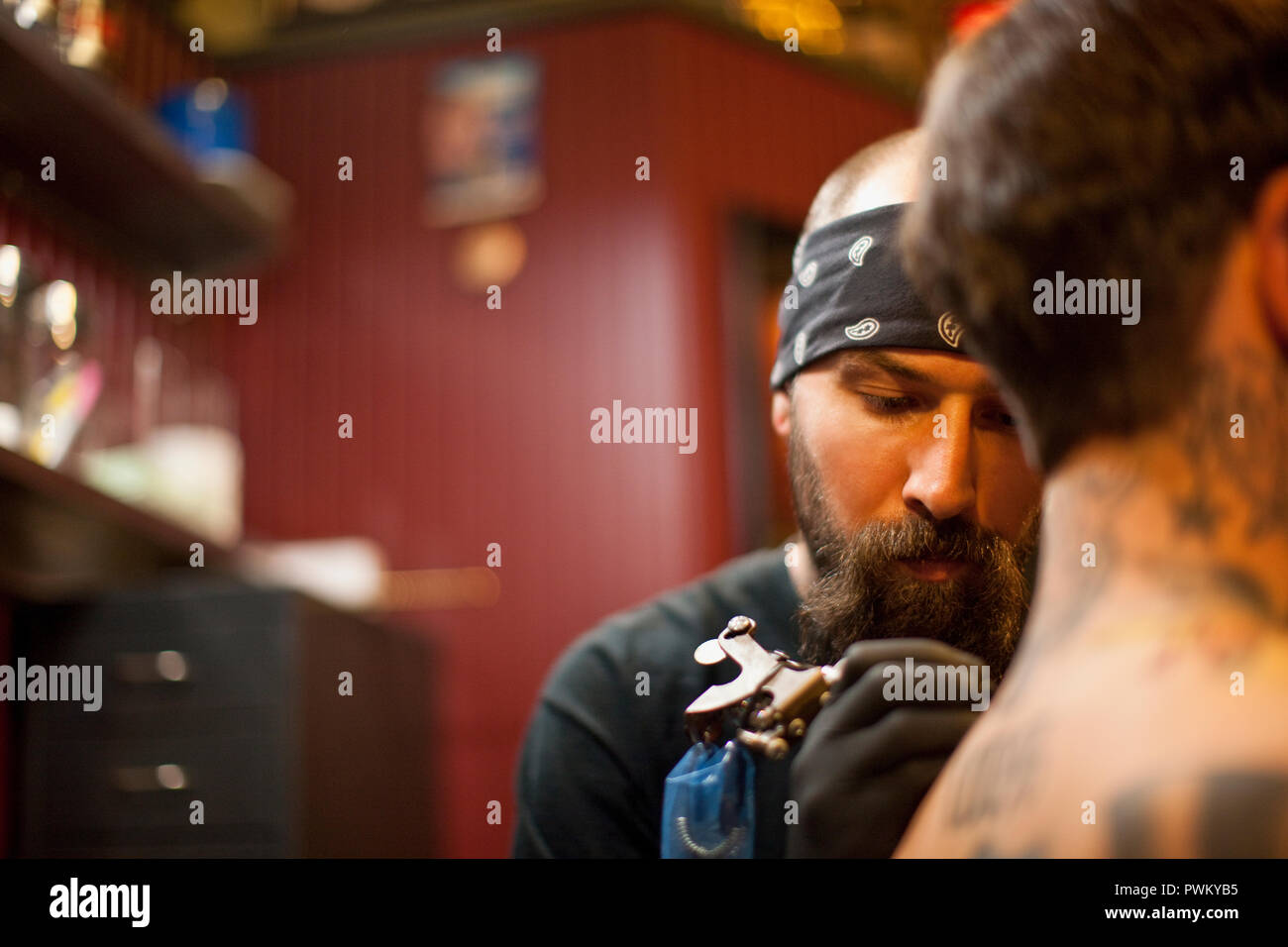 Man getting a tattoo at a tattoo parlour Stock Photo - Alamy