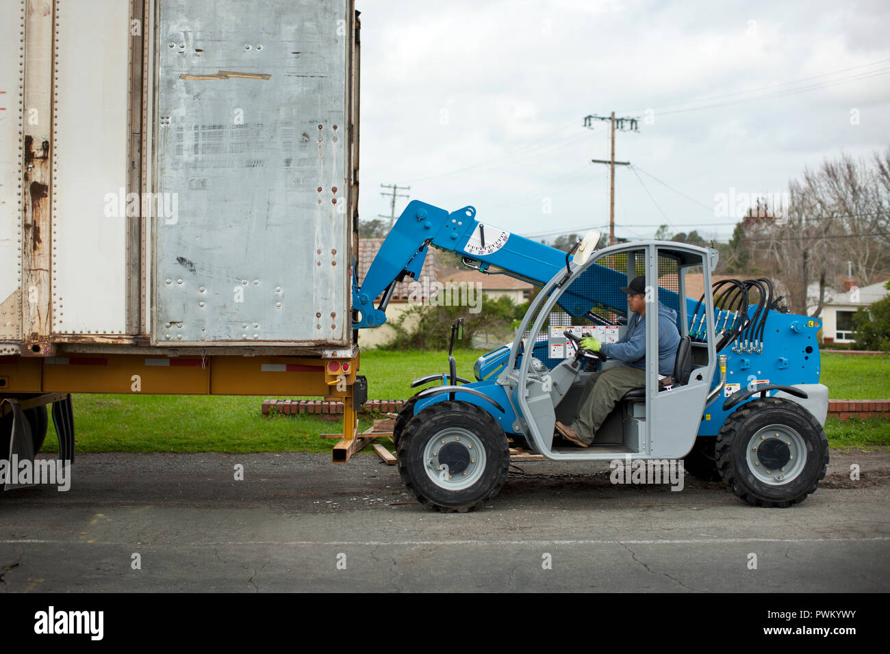 Mid adult man driving a tractor Stock Photo - Alamy