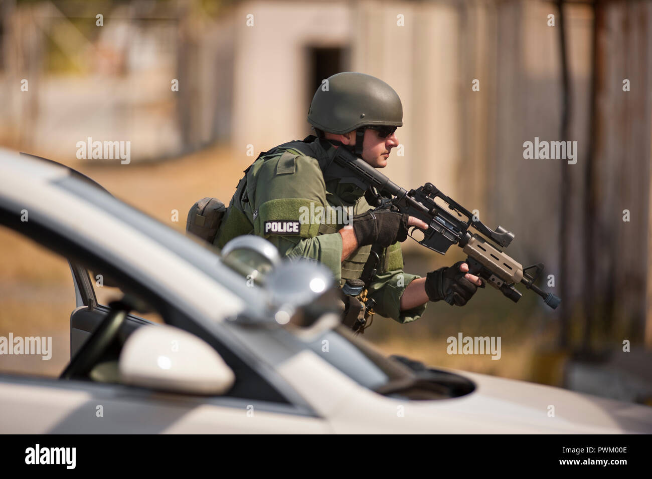 Male police officer holding a gun during an exercise at a training ...